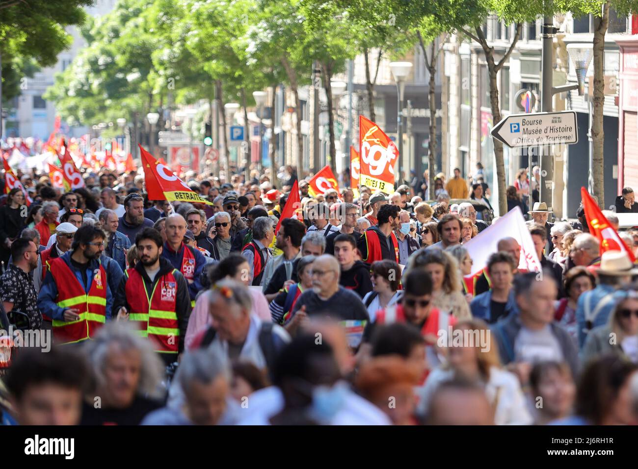 Protesters march through the streets with flags and signs during the ...