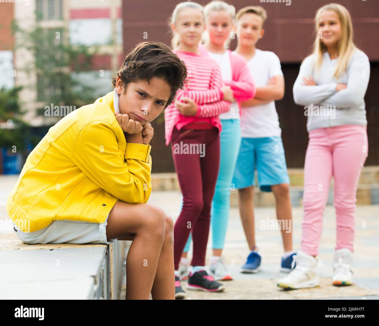 Portrait of boy 9-12 years old who is taking offense on his friends ...