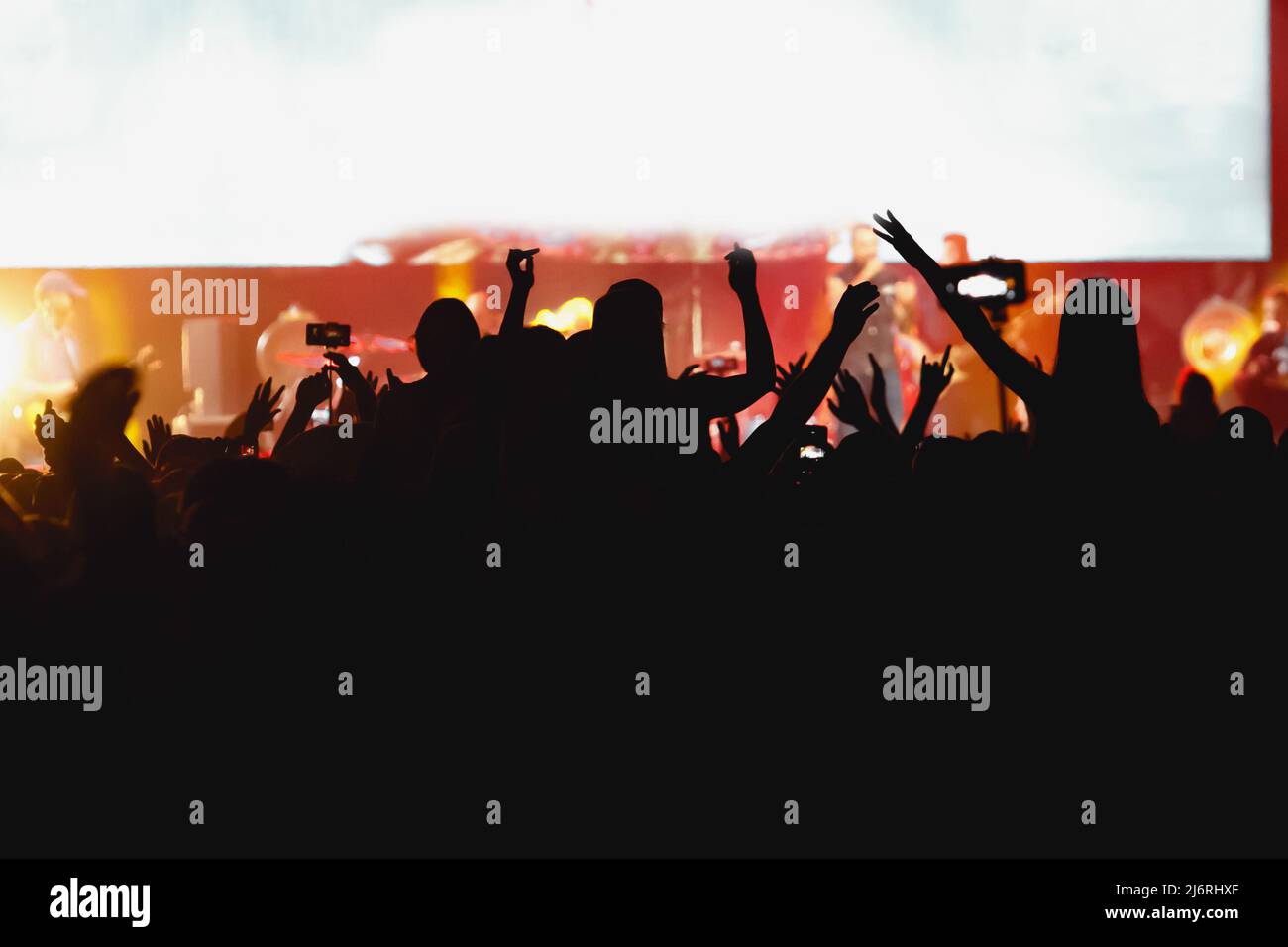 Happy crowd at a concert, people with raised hands at summer music ...