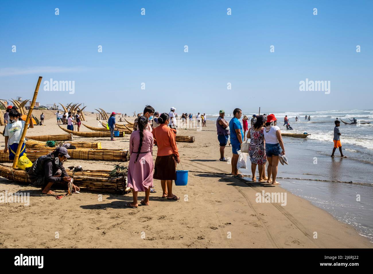 Local People Wait On The Beach For The Return Of The Fishermen In Their ...