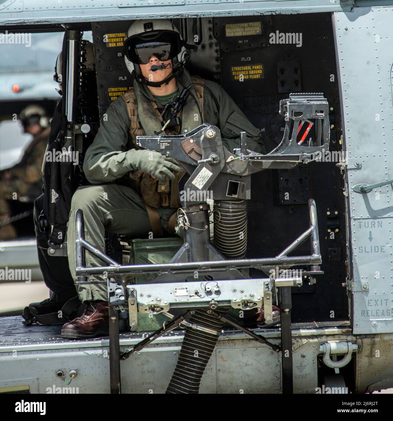 A U.S. Marine aboard a UH-1Y Venom with Marine Light Attack Helicopter ...