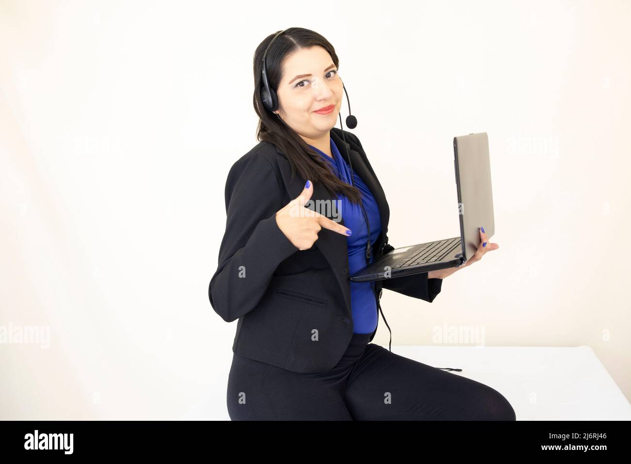 Cute and successful CEO woman, wearing black suit and blue bluse ...