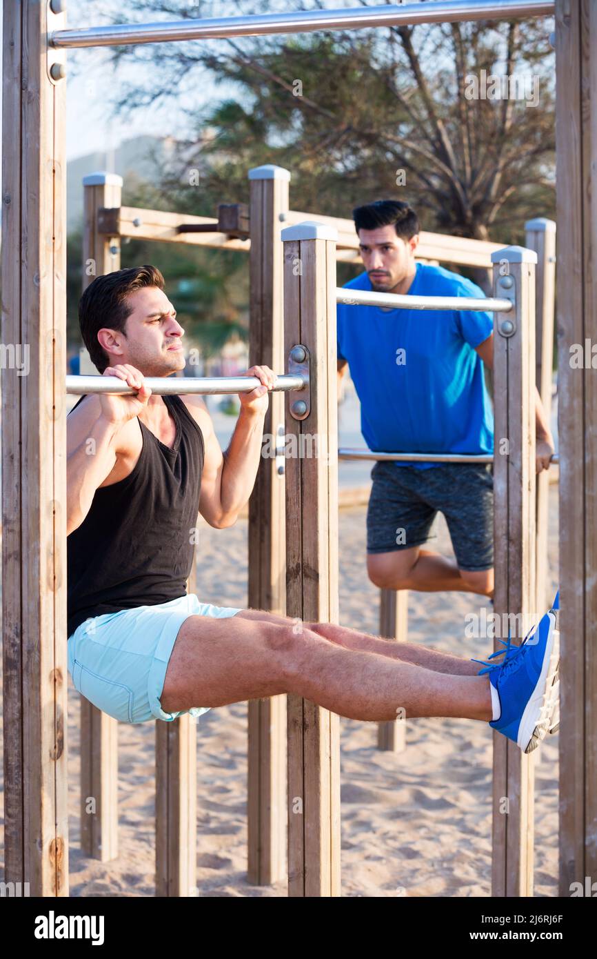Sportsmen doing pull-ups Stock Photo - Alamy