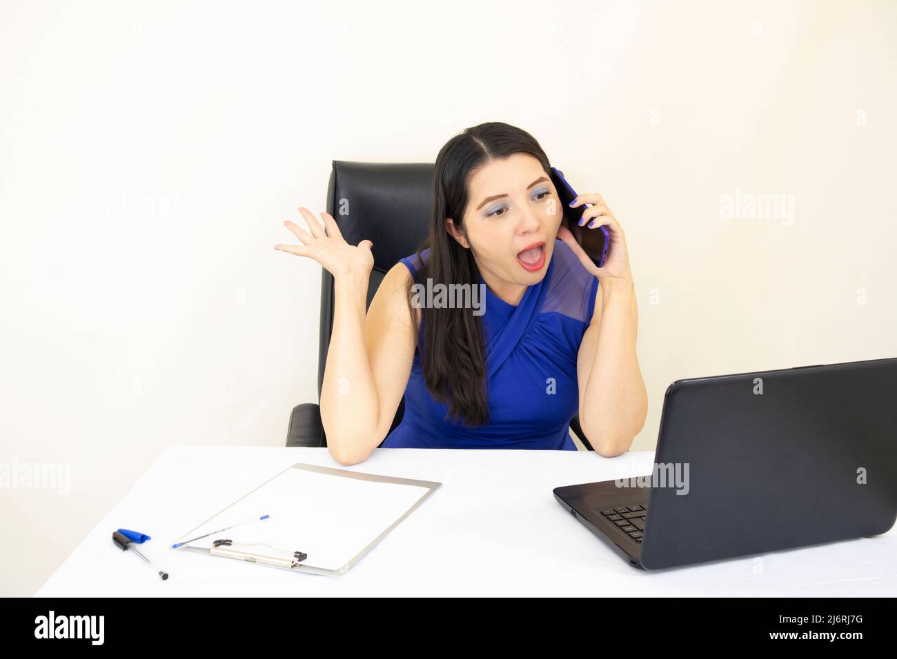 cute successful CEO assistant wearing blue blouse surprised taking call ...