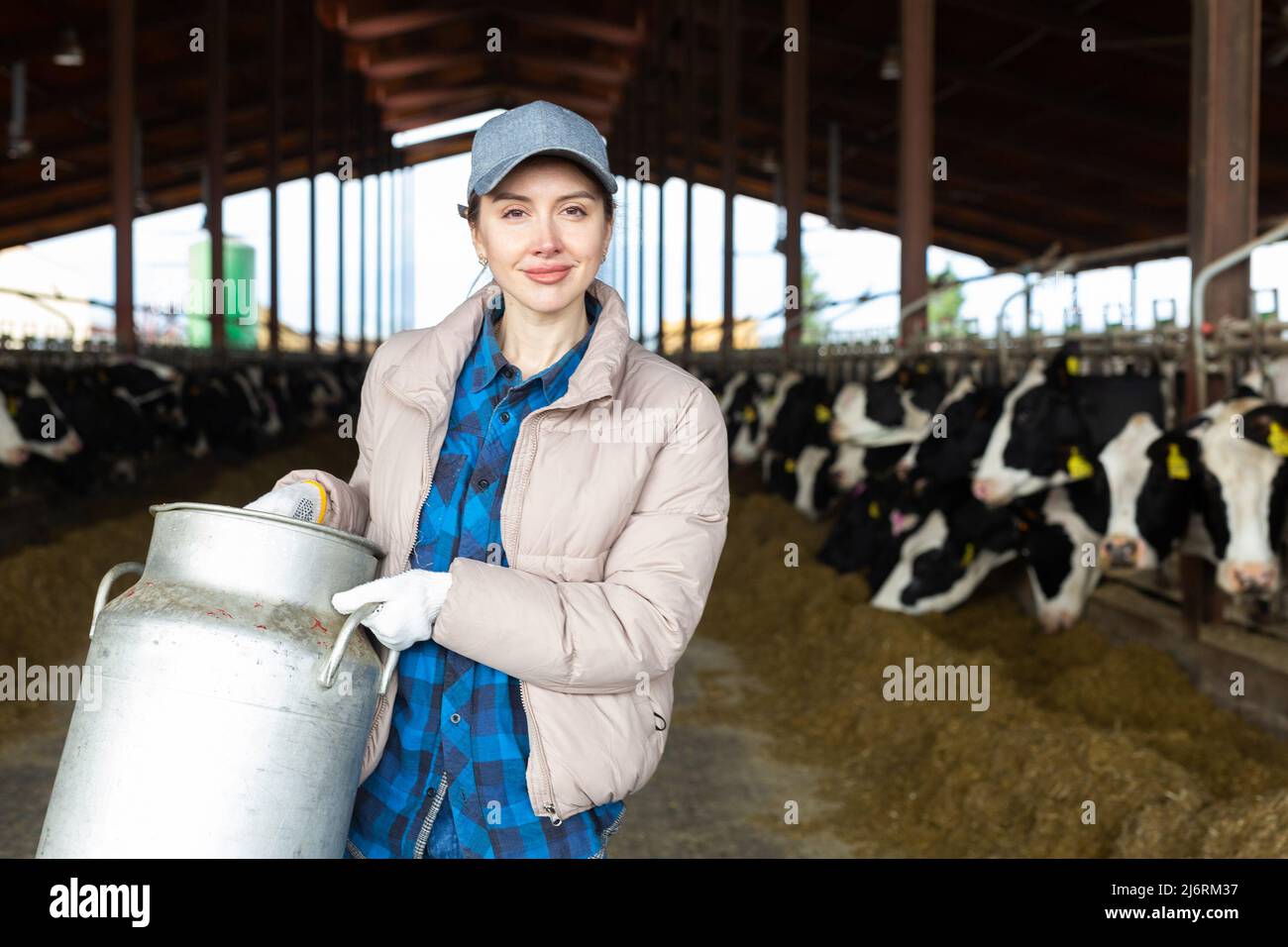 Portraif of woman dairy farm worker with milk can Stock Photo - Alamy