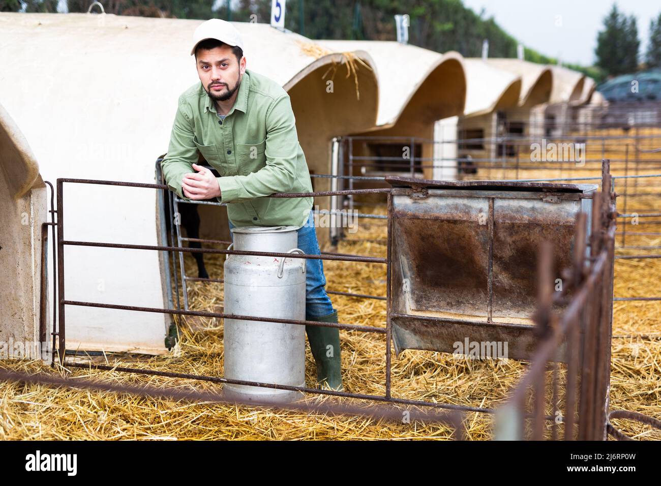 Confident young farmer standing in open stall in livestock farm Stock ...