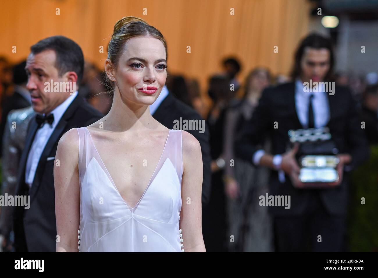 Emma Stone walking on the red carpet at the 2022 Metropolitan Museum of ...
