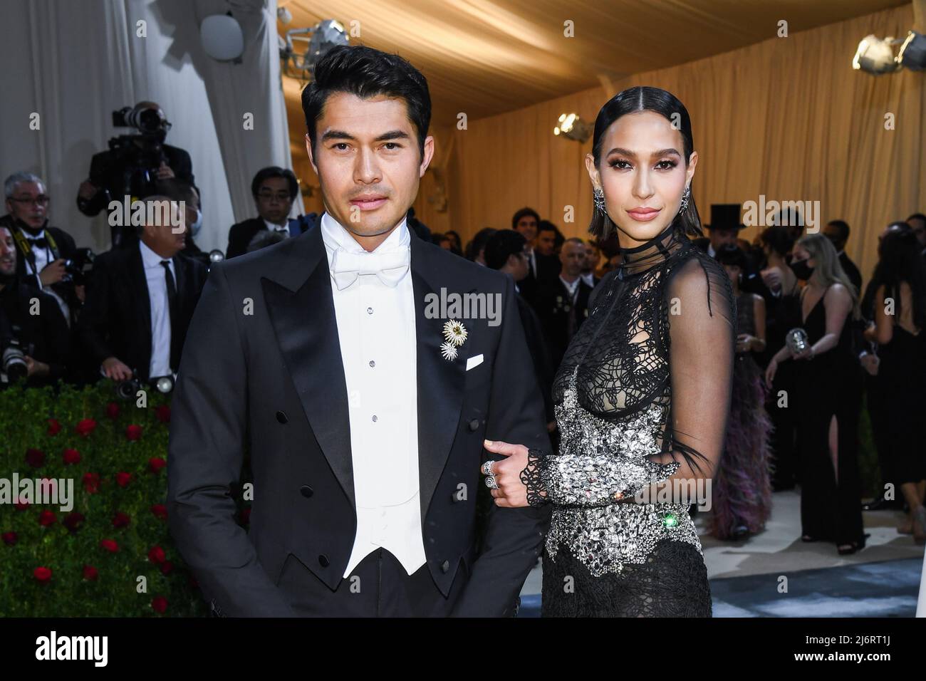 Henry Golding and Liv Lo walking on the red carpet at the 2022 ...