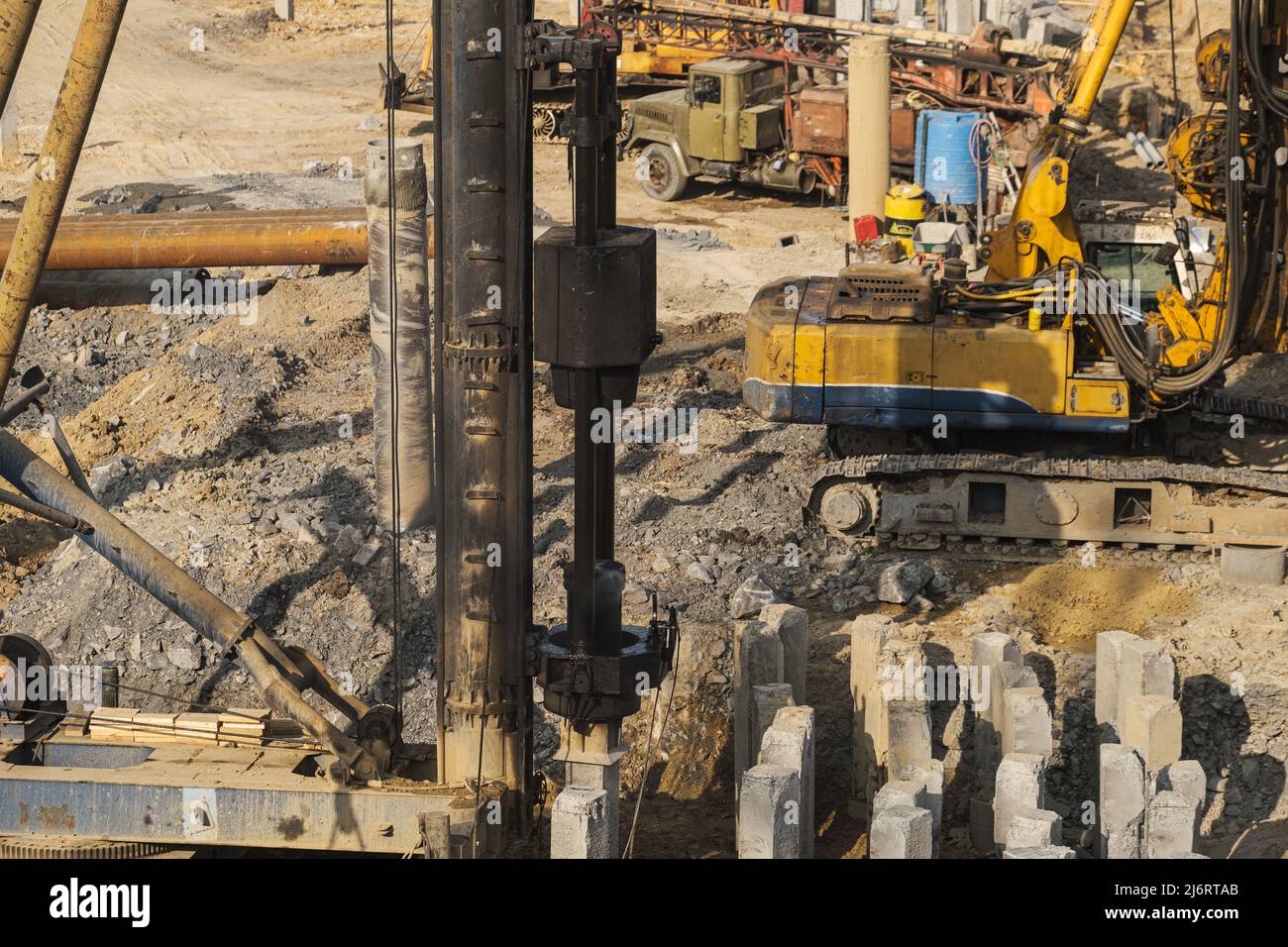 The pile driver drives the pile into the ground Stock Photo - Alamy