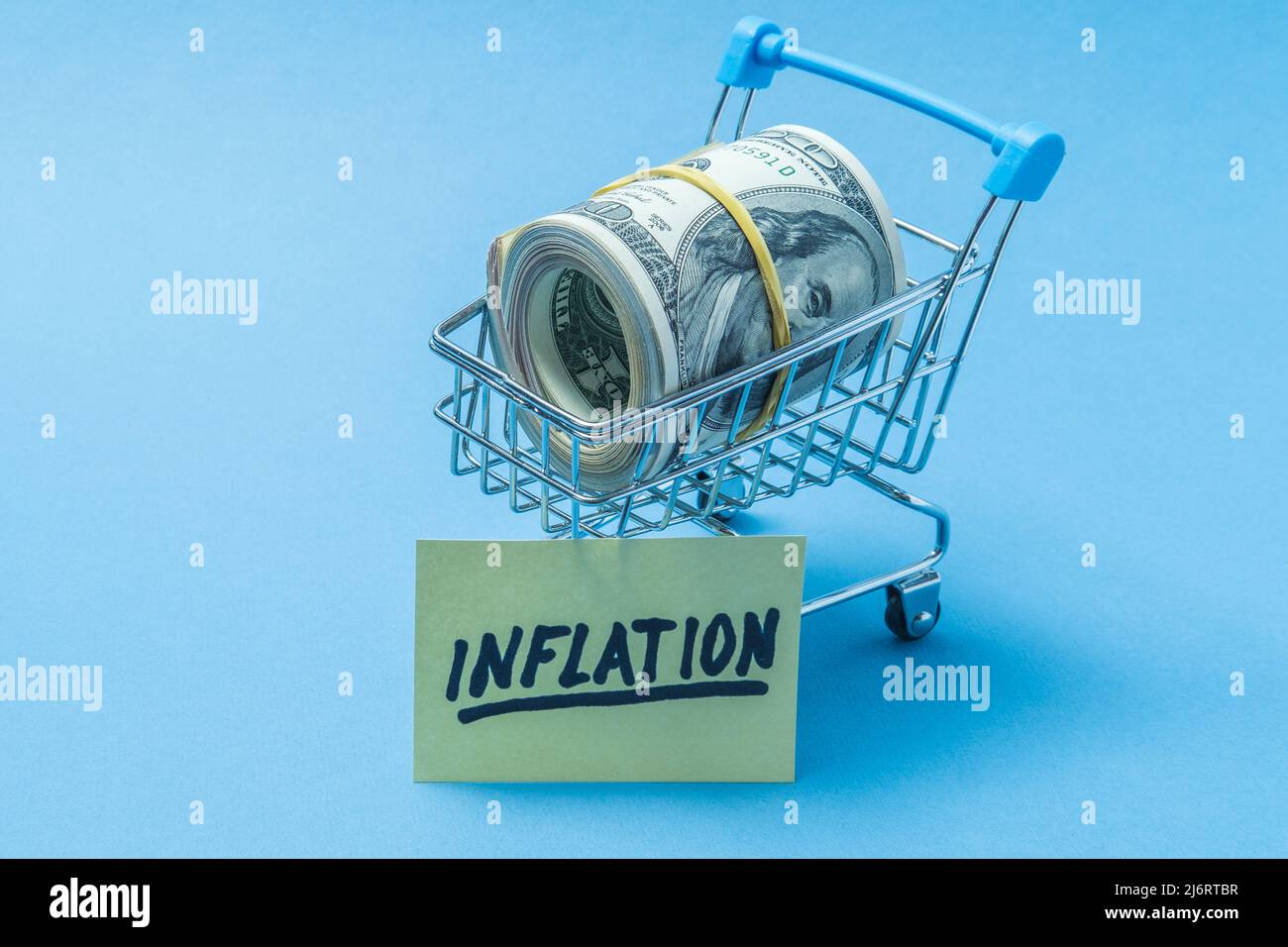 Dollars are in a grocery basket, with a poster on which the inscription ...