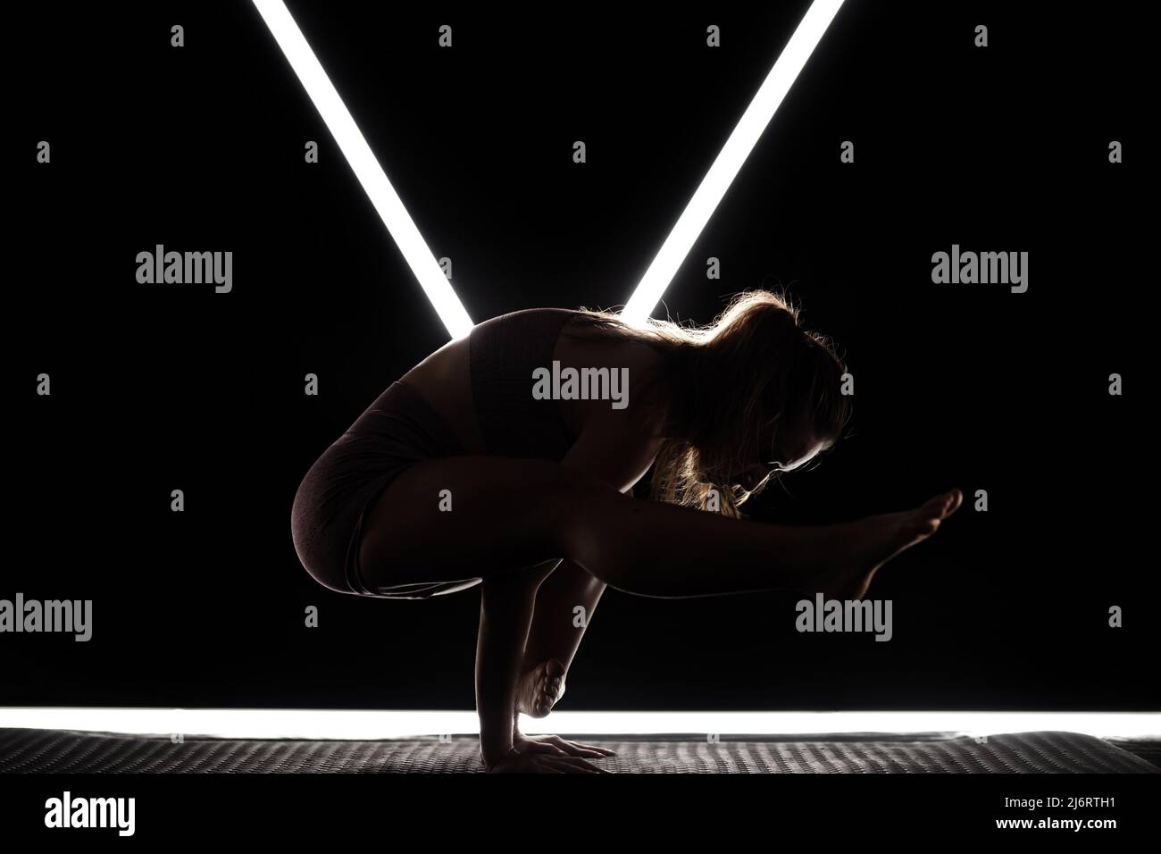 Fit woman practicing yoga poses. Silhouette girl doing exercise in ...