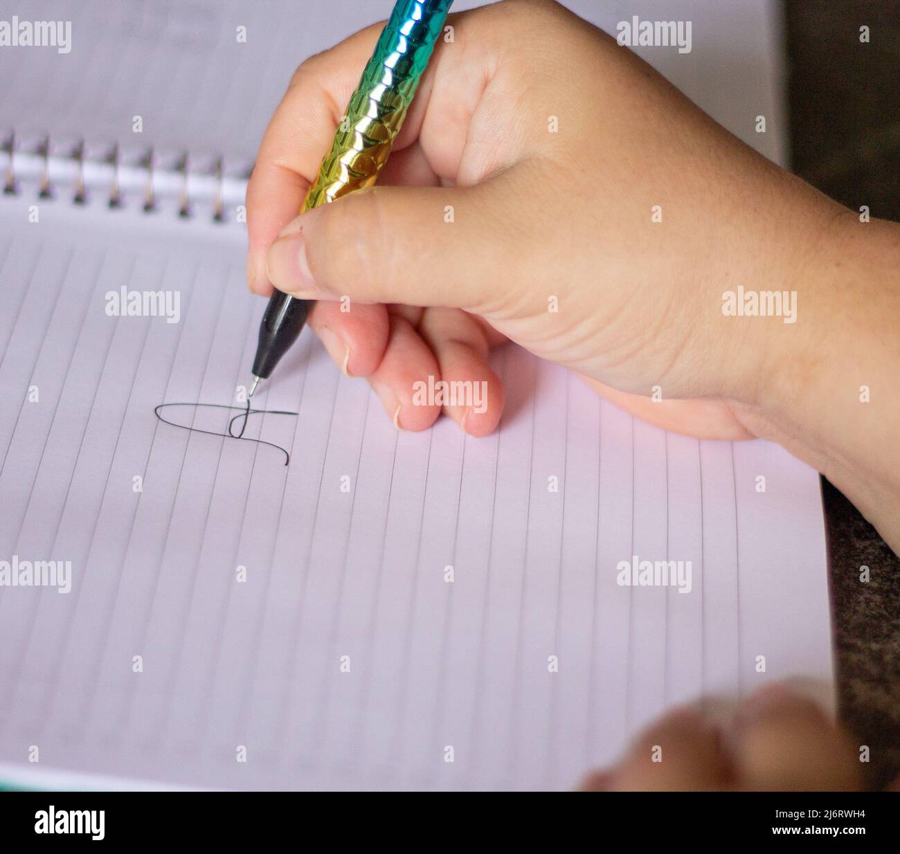 Handwritten letter A, female hand holding a colored pen in the shape of ...