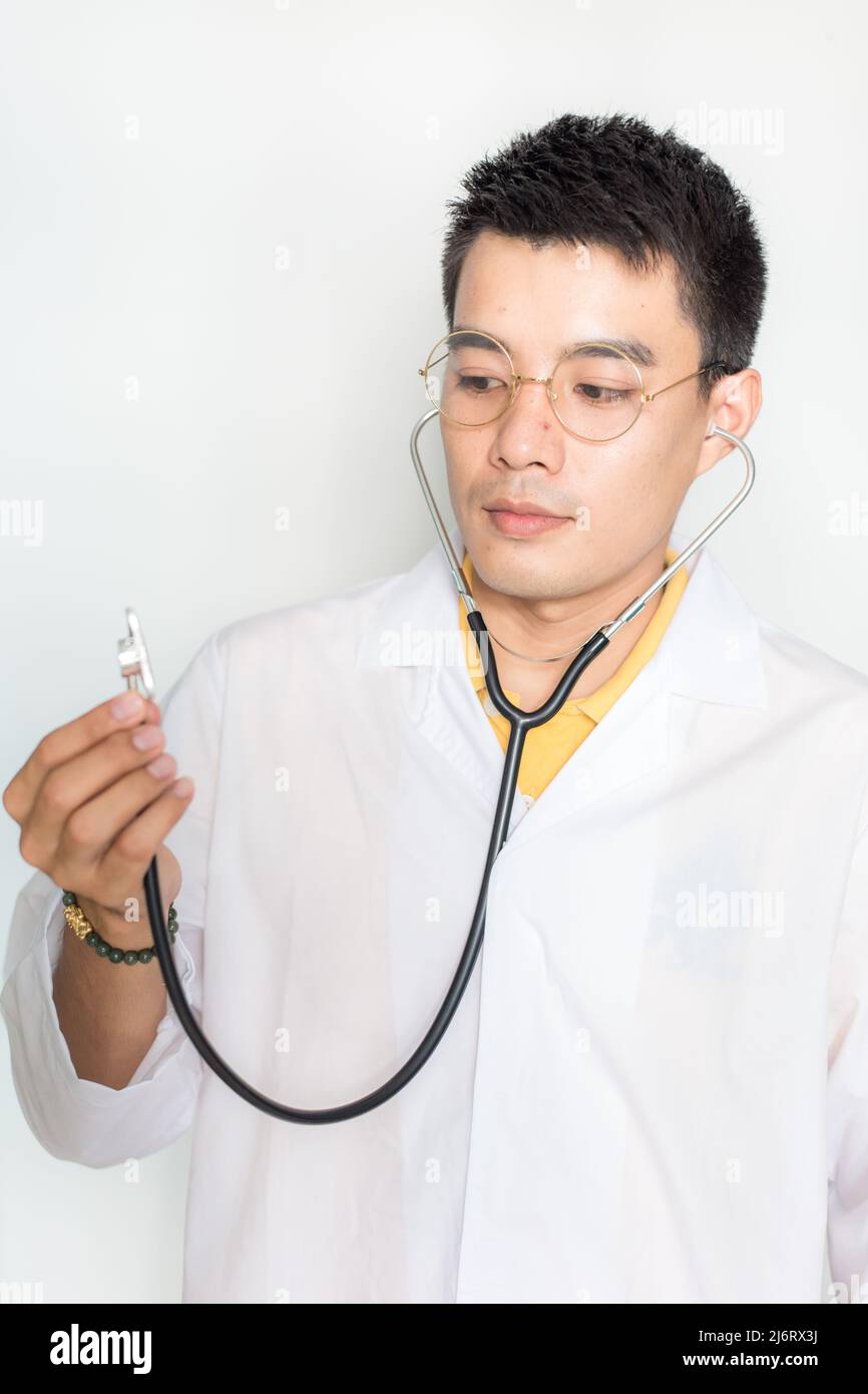 Smart asian professional doctor holding with a stethoscope on white ...