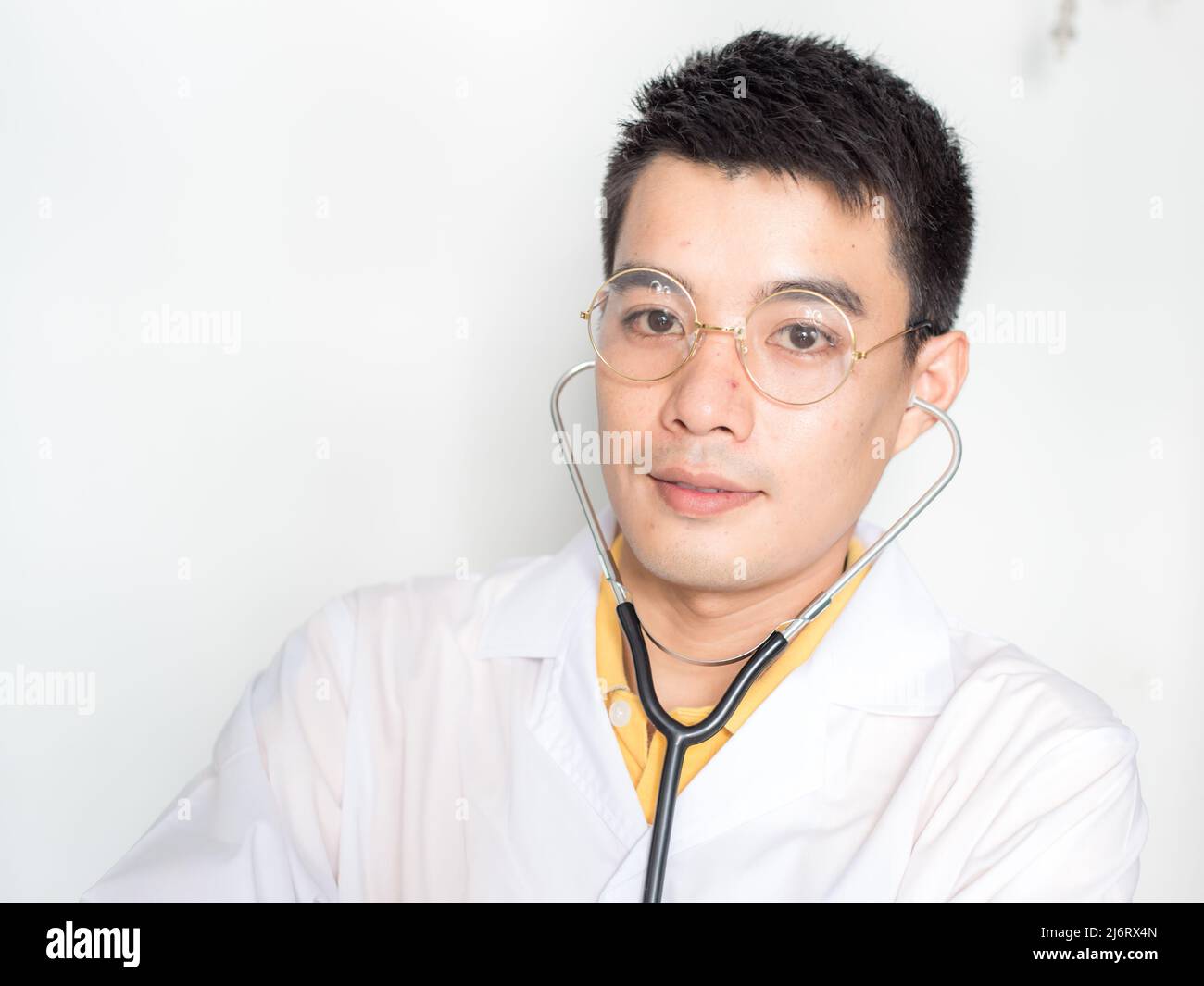 Smart asian professional doctor holding with a stethoscope on white ...