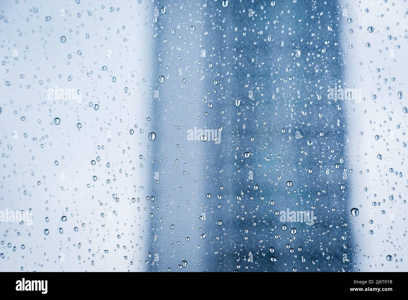 Abstract image of Rain drops on the dirty glass windows with modern ...