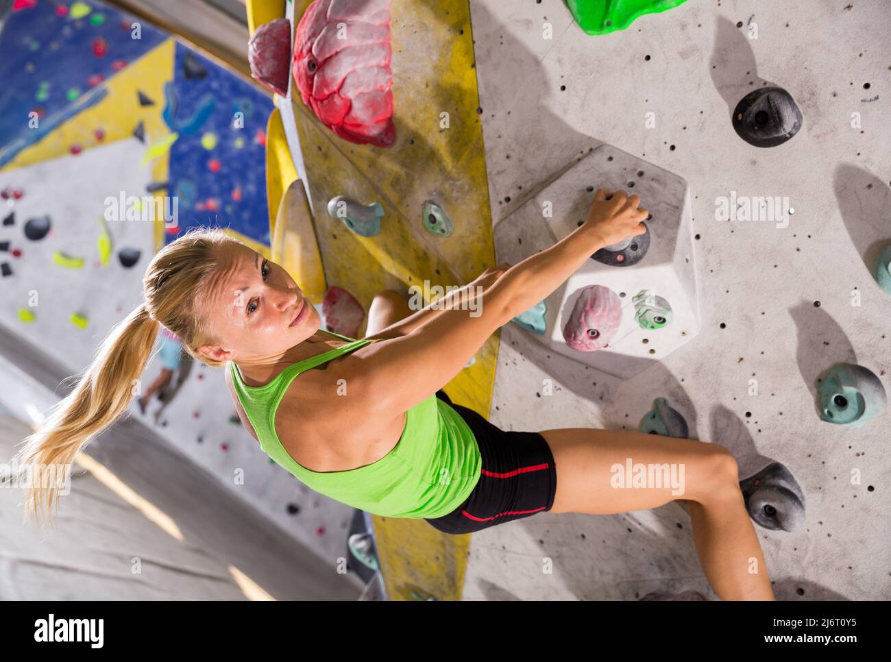 Female practicing indoor rock-climbing Stock Photo - Alamy