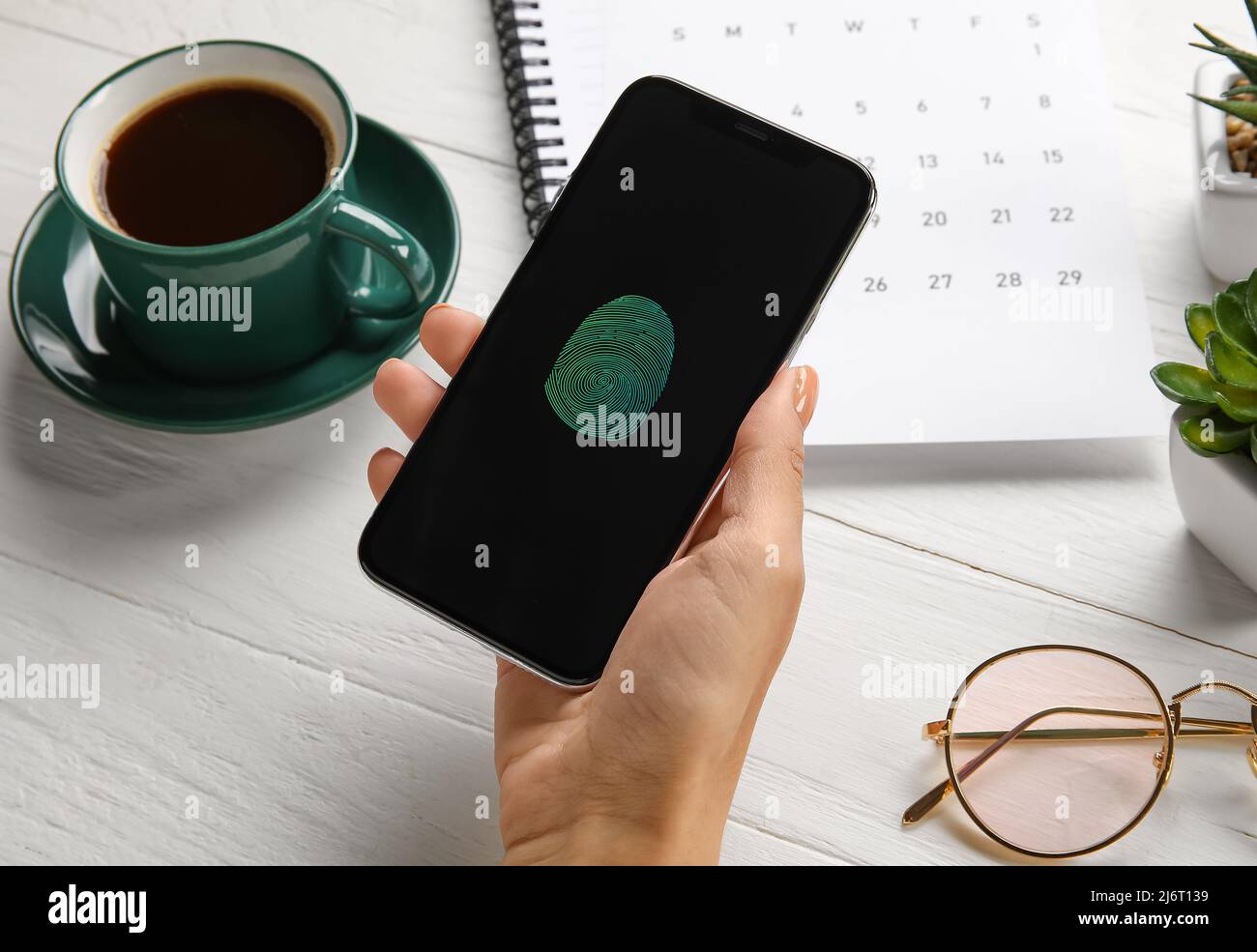 Woman with smartphone using fingerprint scanner to login into personal ...