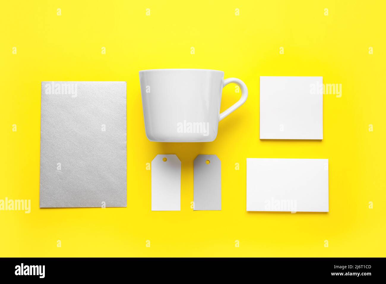 Blank cup, cards and tags on yellow background Stock Photo - Alamy
