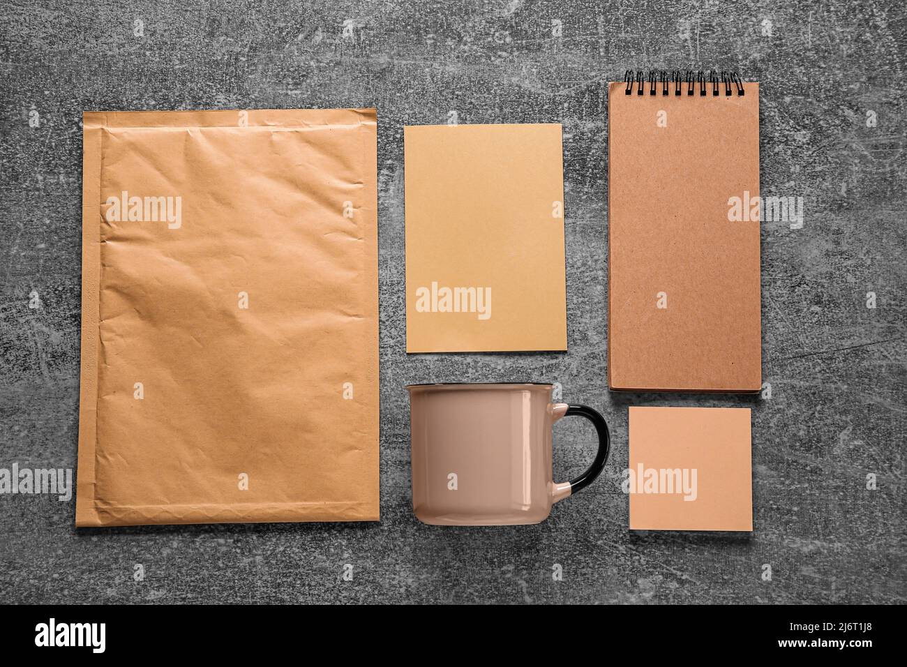 Composition with blank cup, notebook, paper bag, card and sticky notes ...