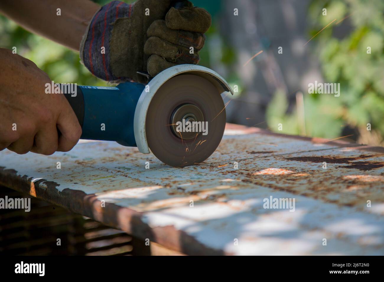 A man cuts a metal structure with a special tool Stock Photo - Alamy