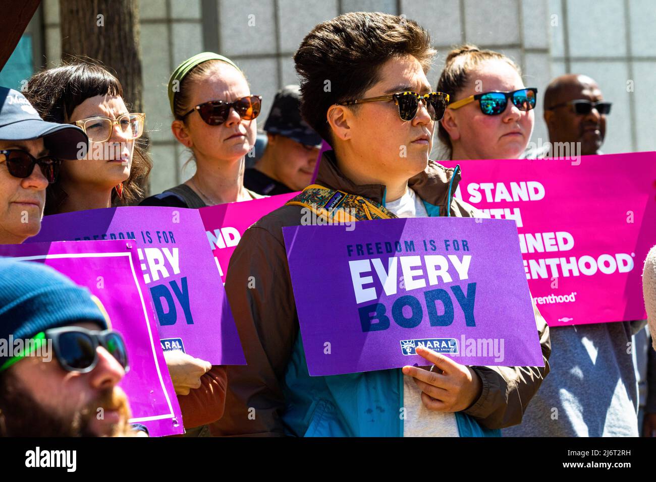Protestors hold signs expressing their opinion during the demonstration ...