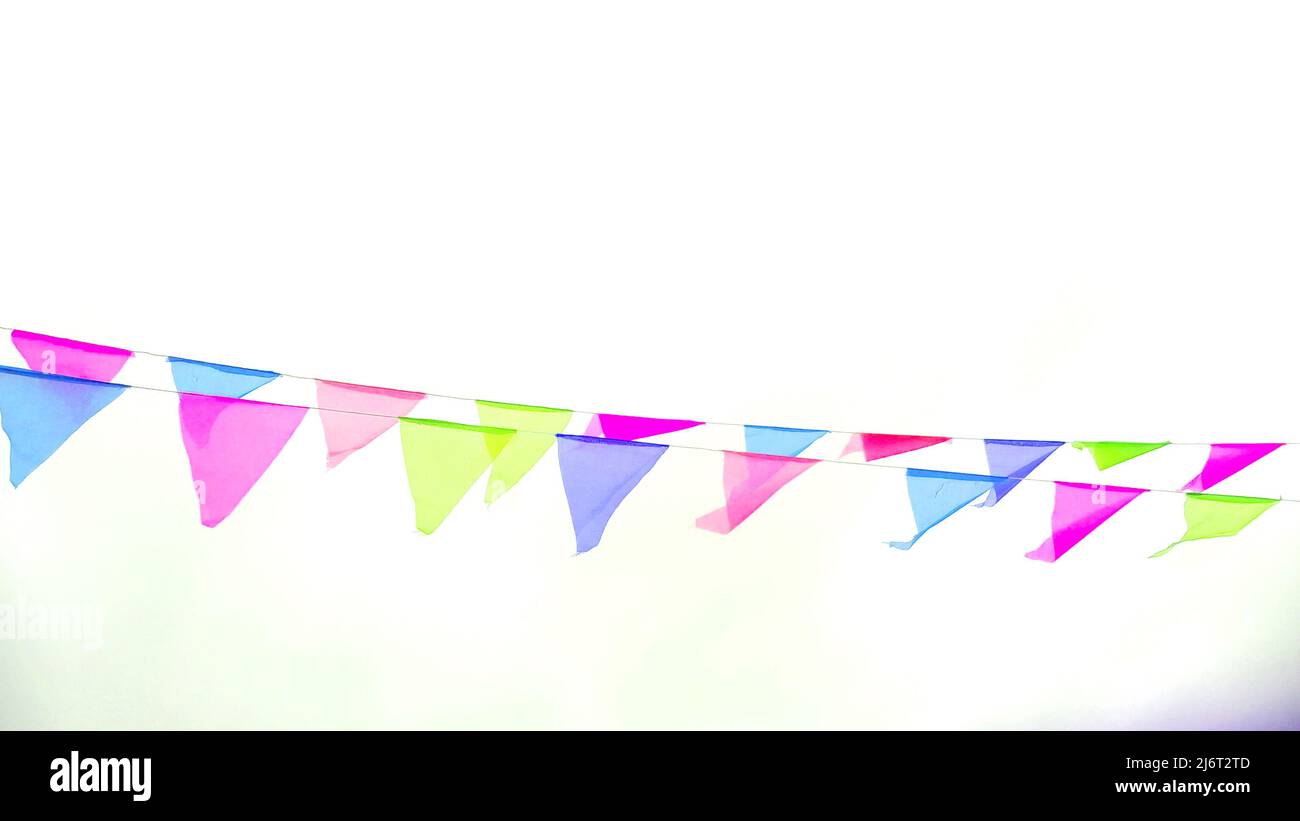 Multicolored triangular flags hang on a string and flutter in the wind ...