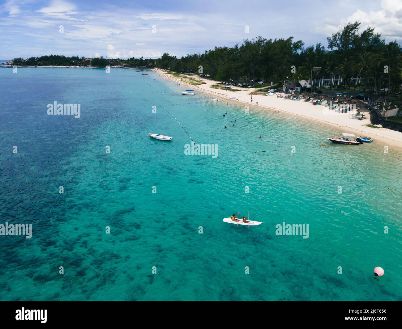 couple of men and woman in Kayak in the blue ocean of Mauritius, couple ...