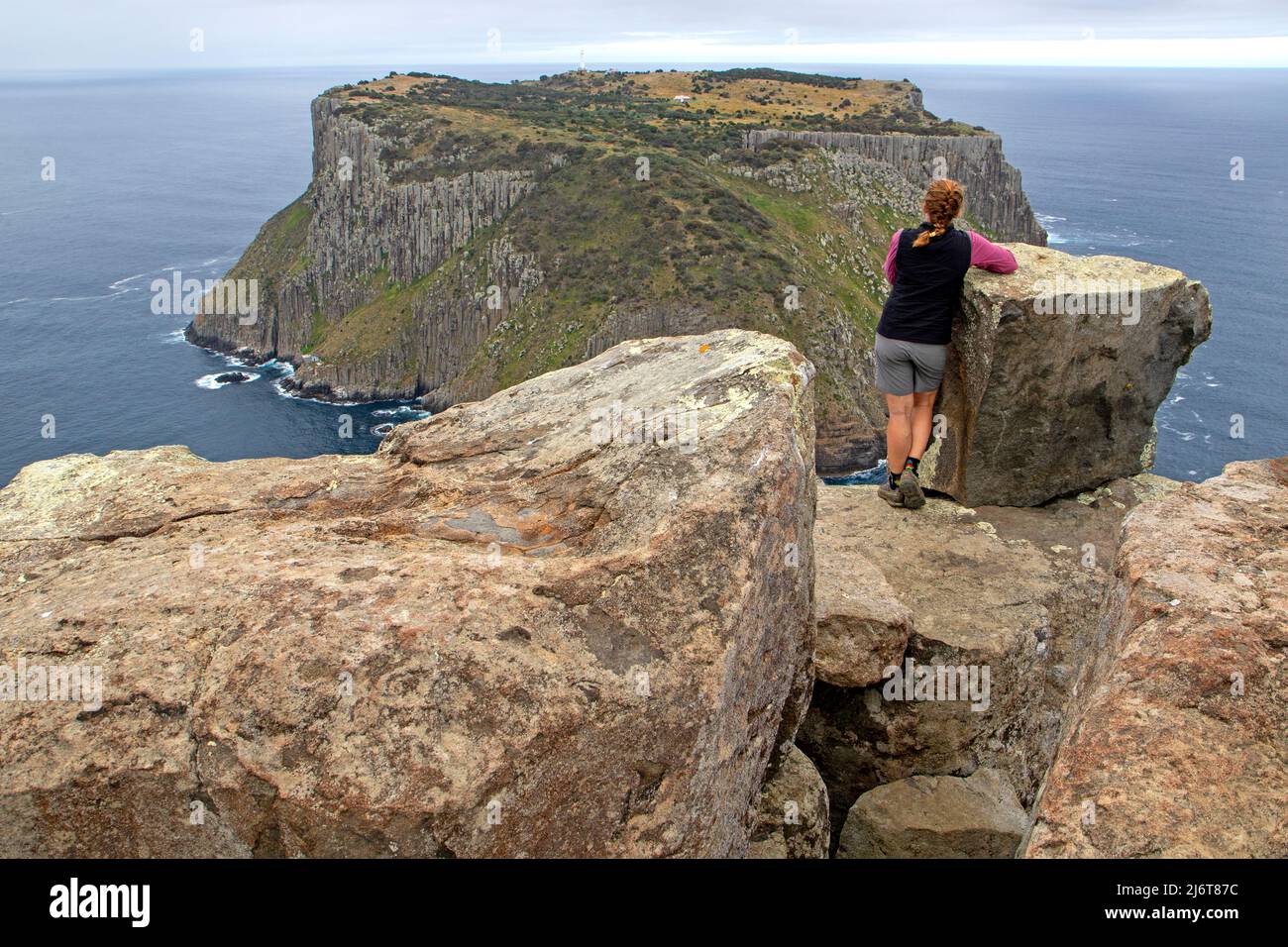 Woman on the Blade at Cape Pillar on the Three Capes Track Stock Photo ...