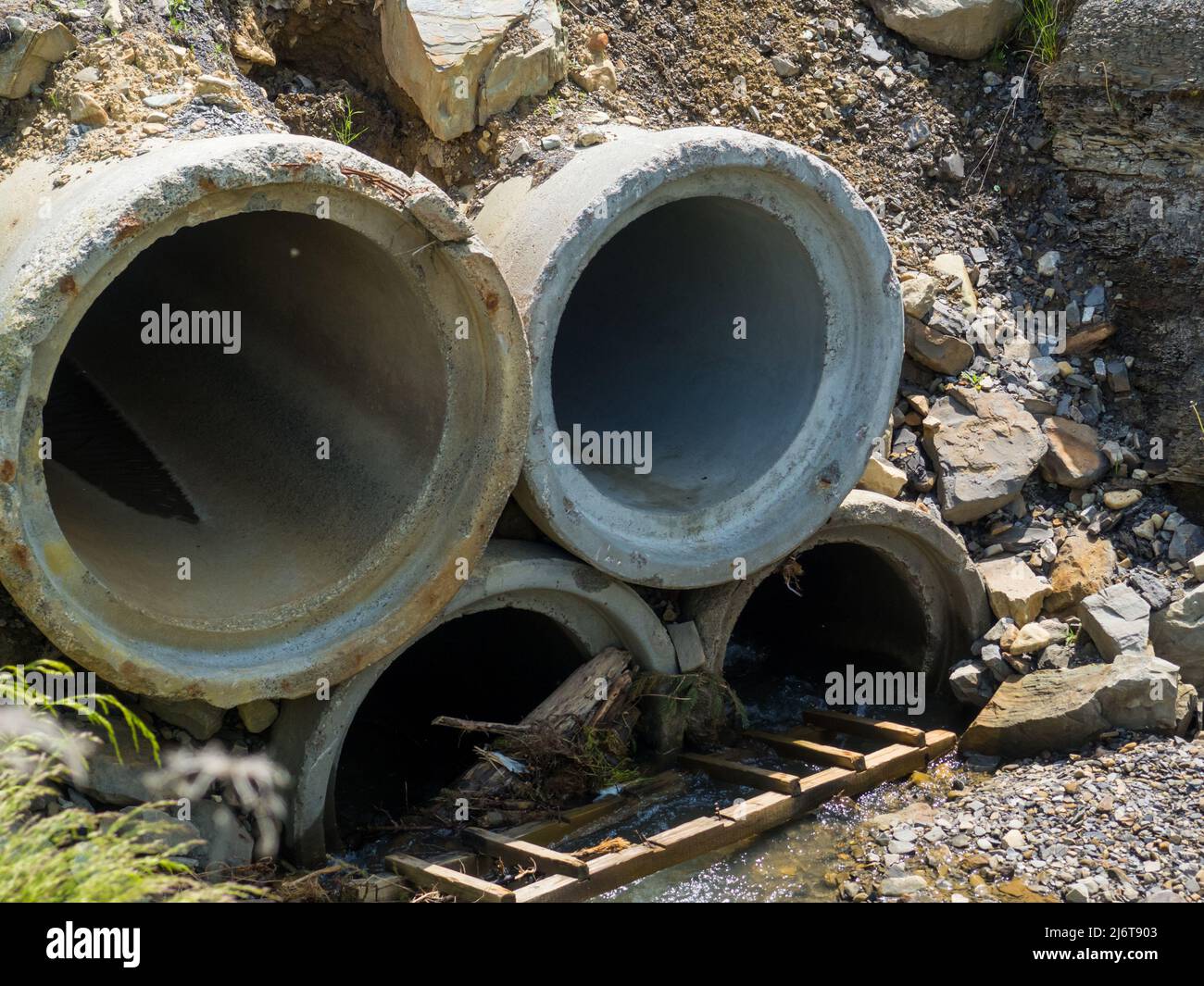 concrete storm sewer pipes are blocked by garbage Stock Photo - Alamy