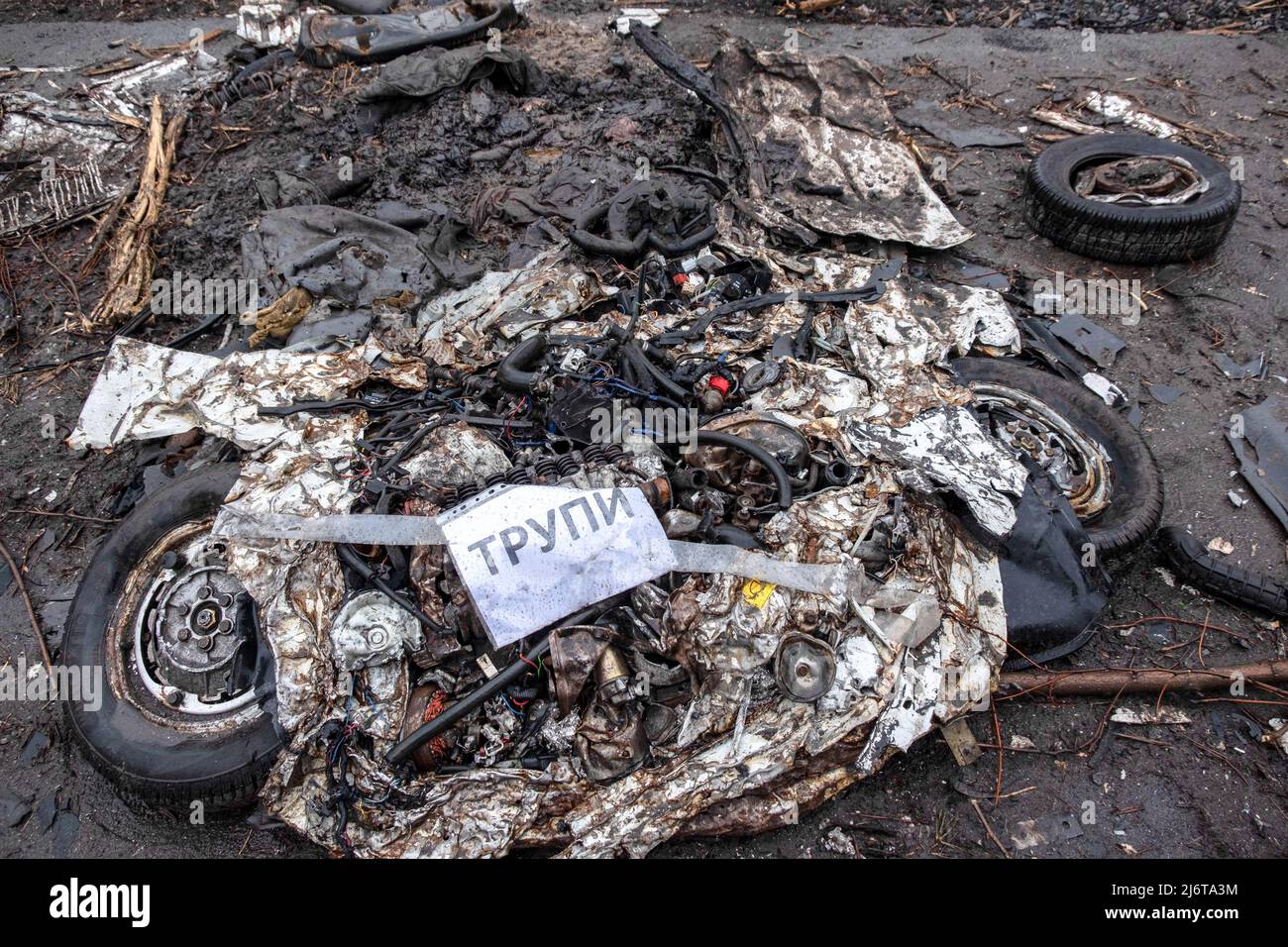A car was destroyed by a tank. The cartel says "CORPSE" to indicate ...