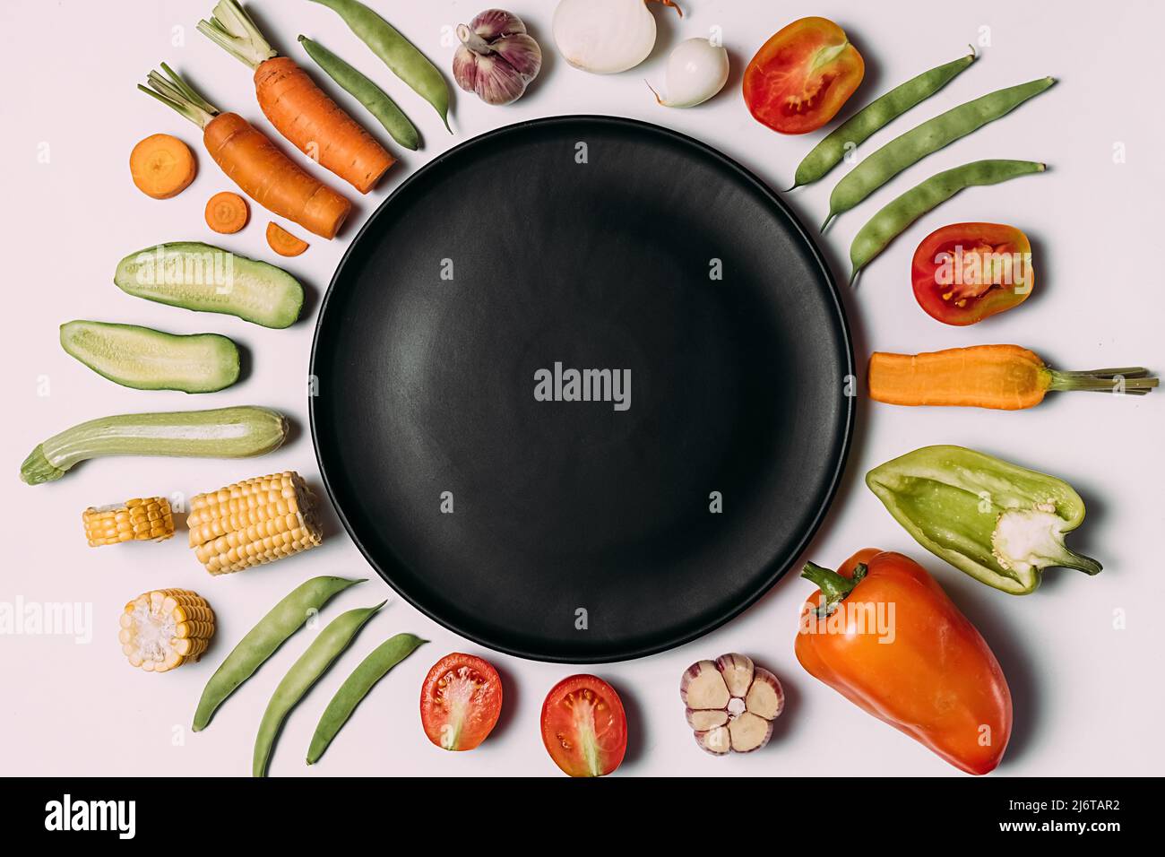 Creative layout made of haricot, tomatoes, pepper, carrot, garlic, corn ...