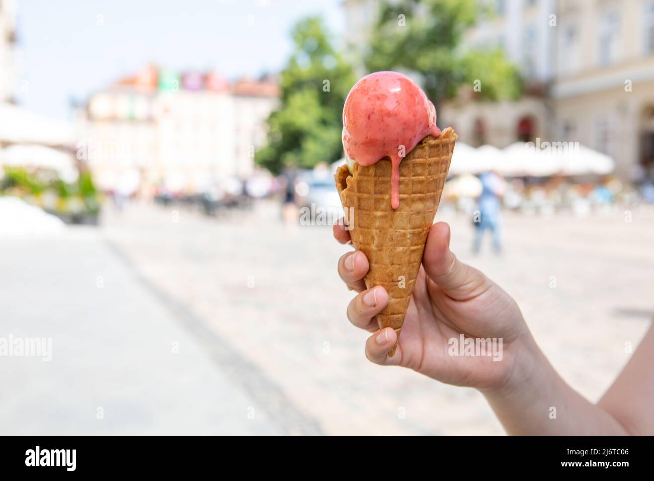 woman hand holding melting ice cream at hot summer day Stock Photo - Alamy