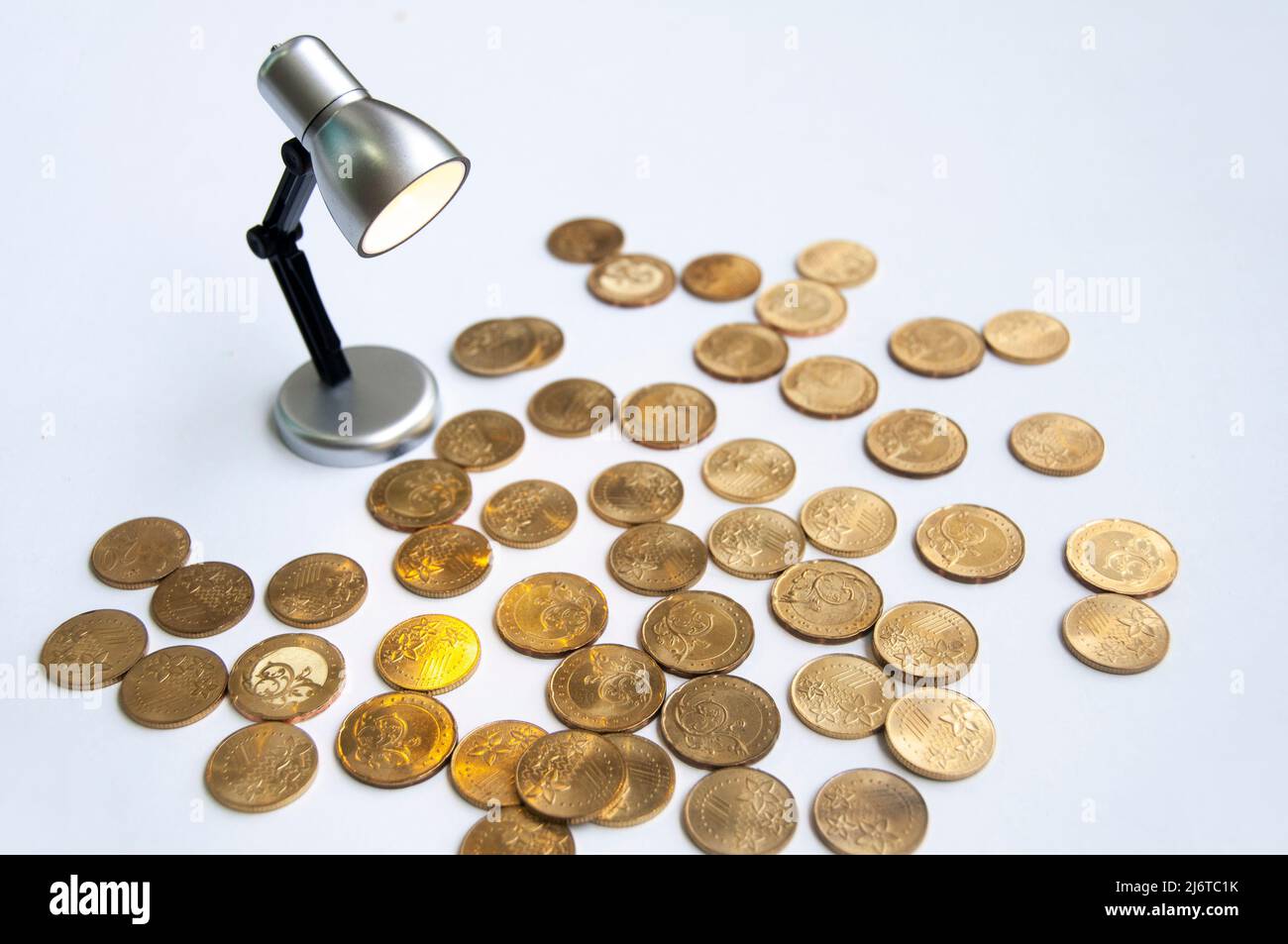 Lamp with gold coins on white background. Business and copy space ...