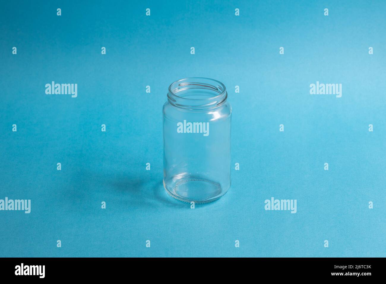 Glass jar without lid with blue bottom Stock Photo - Alamy
