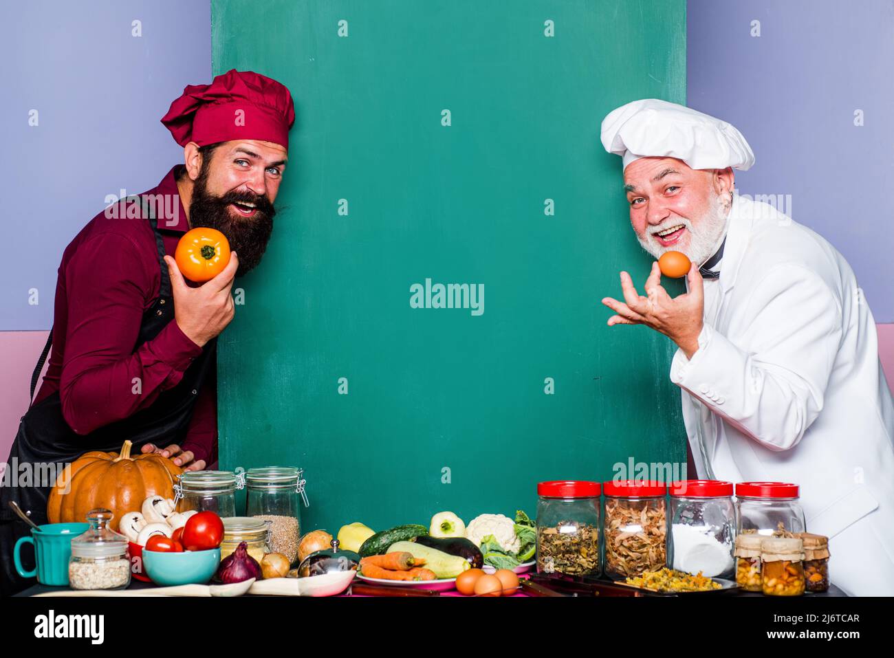 Happy Chef showing Menu Board. Chef, cook or baker by empty chalkboard ...