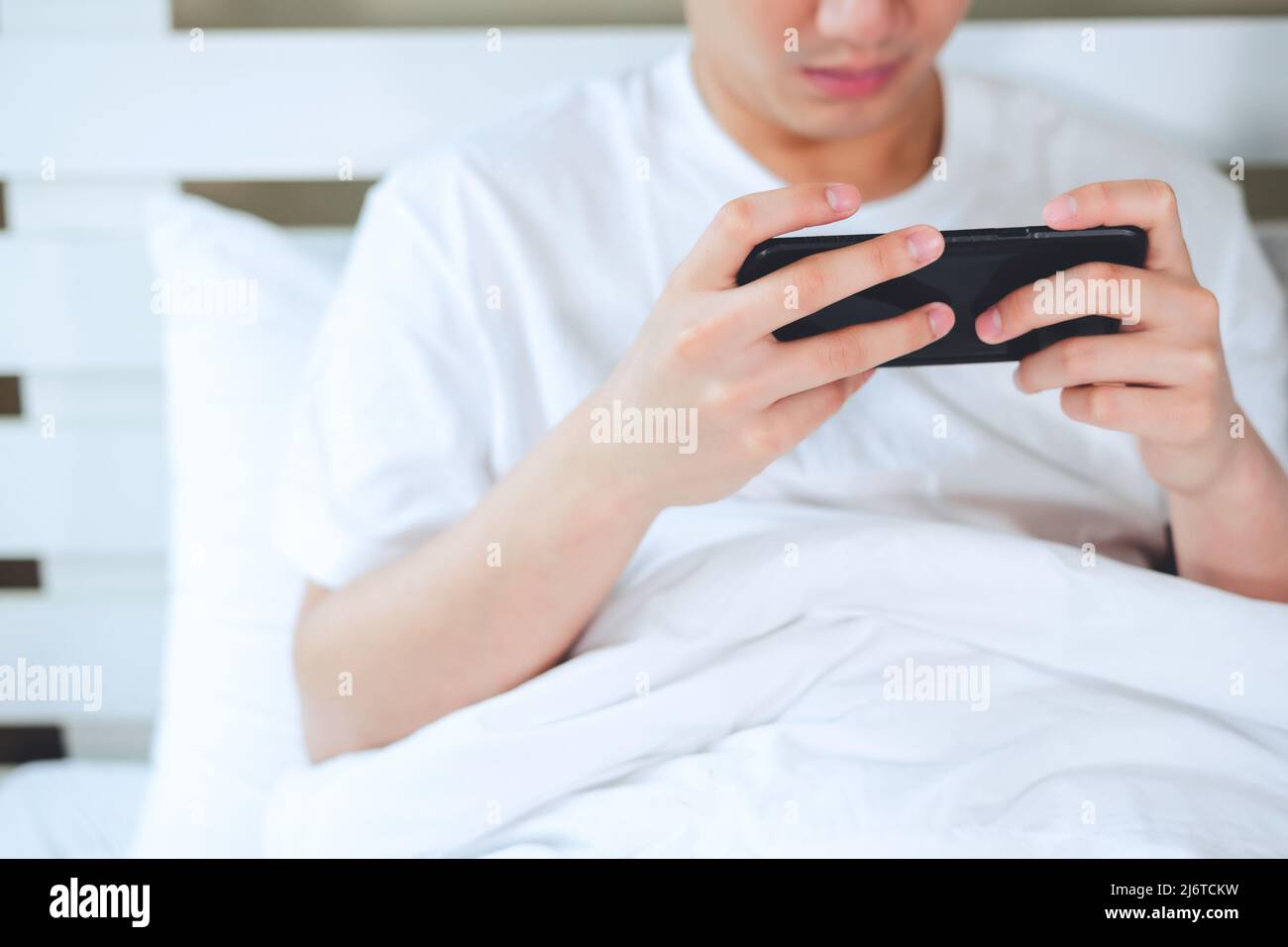 man playing game on phone Stock Photo - Alamy