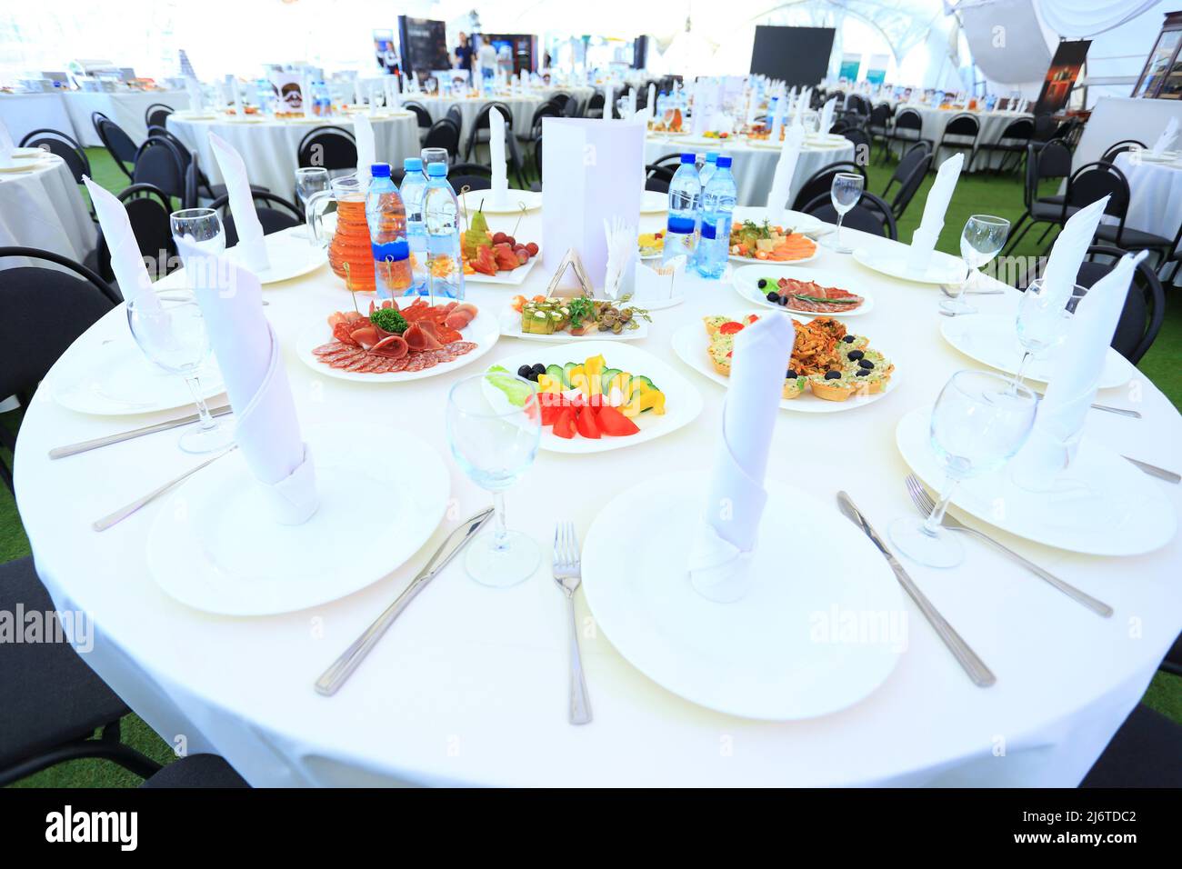 catering table set service with silverware and glass stemware at ...