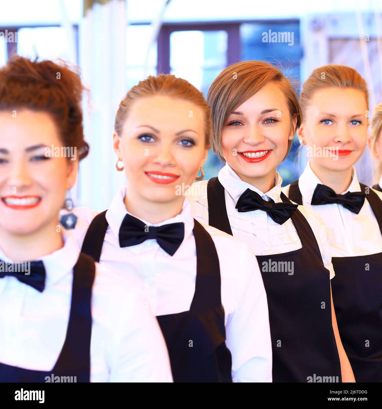 Large group of waiters and waitresses standing in row Stock Photo - Alamy