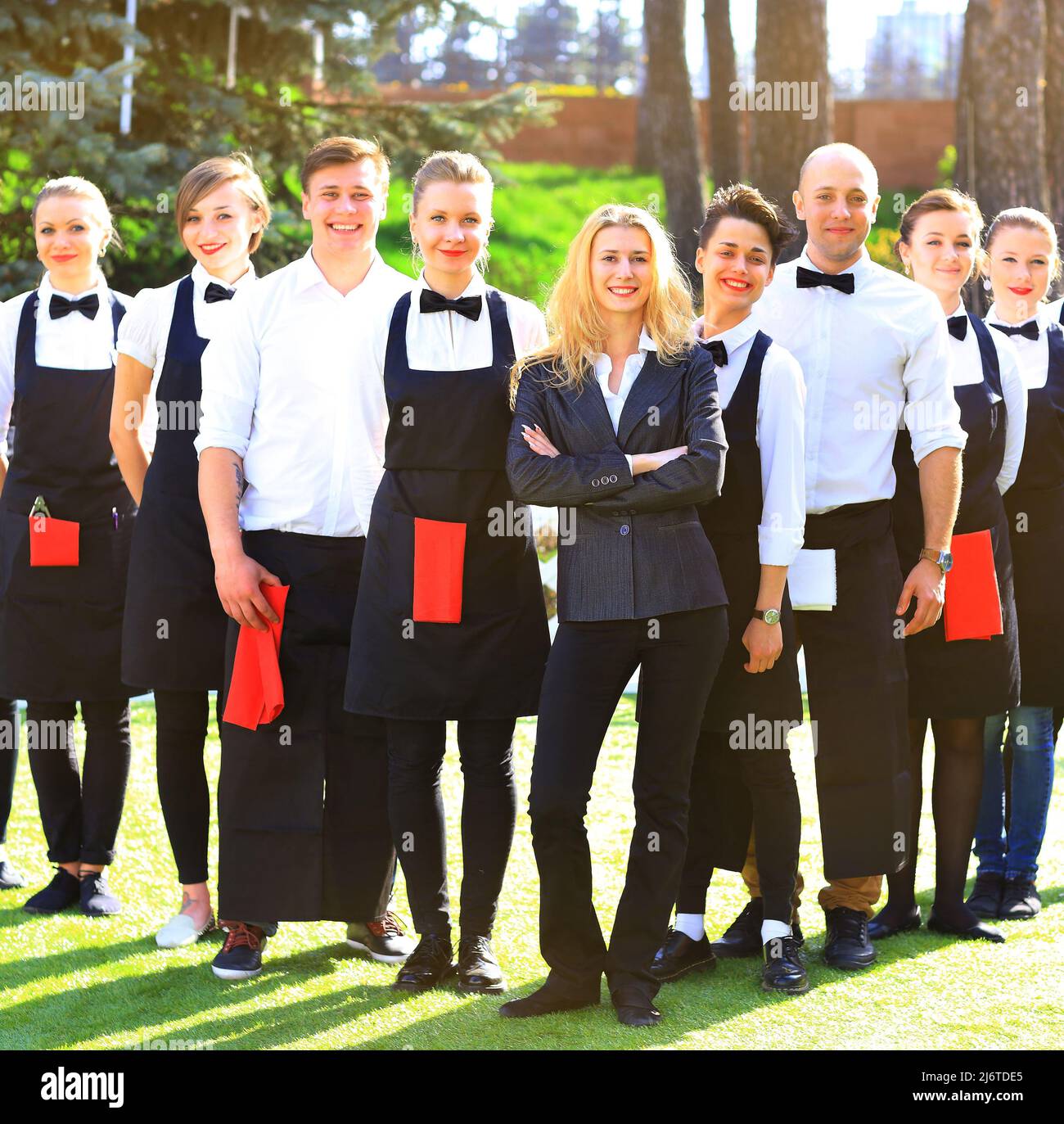 Large group of waiters and waitresses standing in row Stock Photo - Alamy