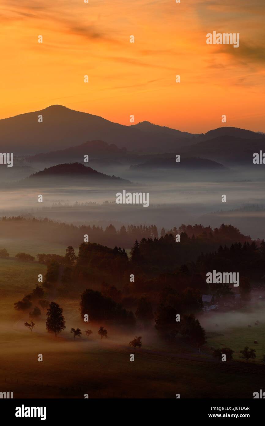 Cold misty foggy morning with sunrise in a fall valley of Bohemian ...