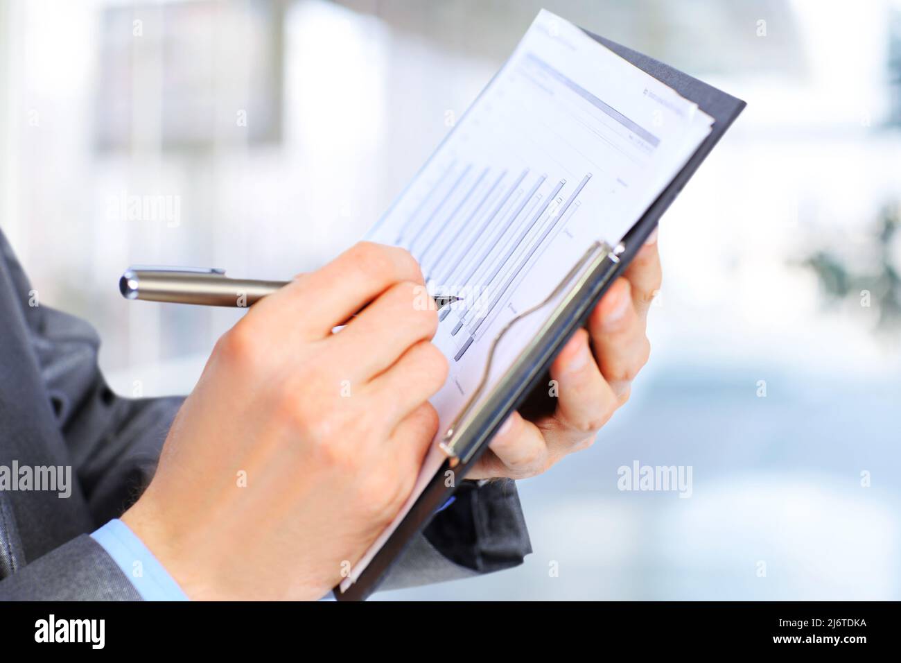 Folder for documents closeup in focus. Businessman writing in office ...