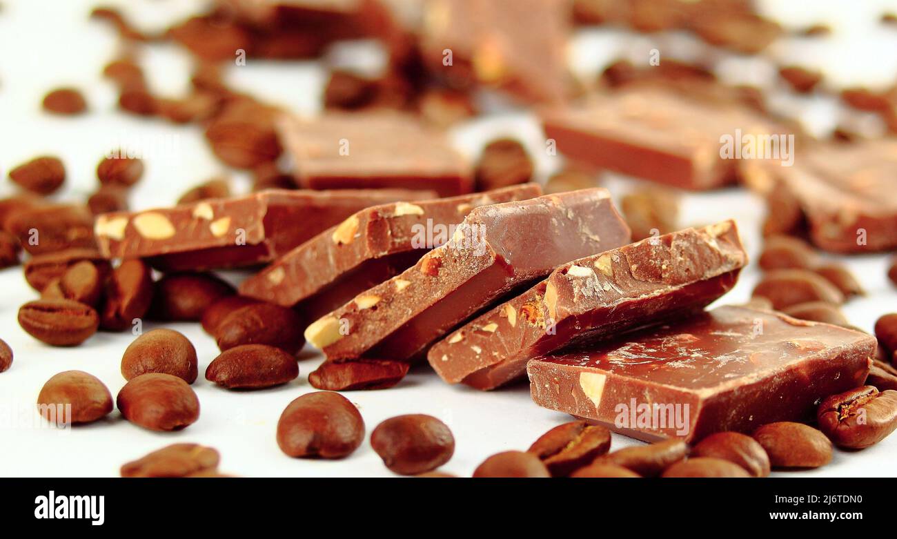 sweet chocolate candies and coffee beans isolated on white background ...