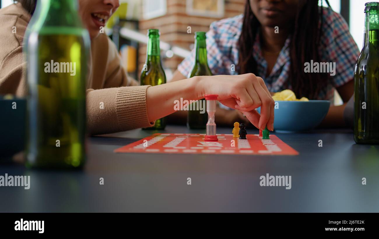 Diverse group of friends playing charades board games and fun gathering ...