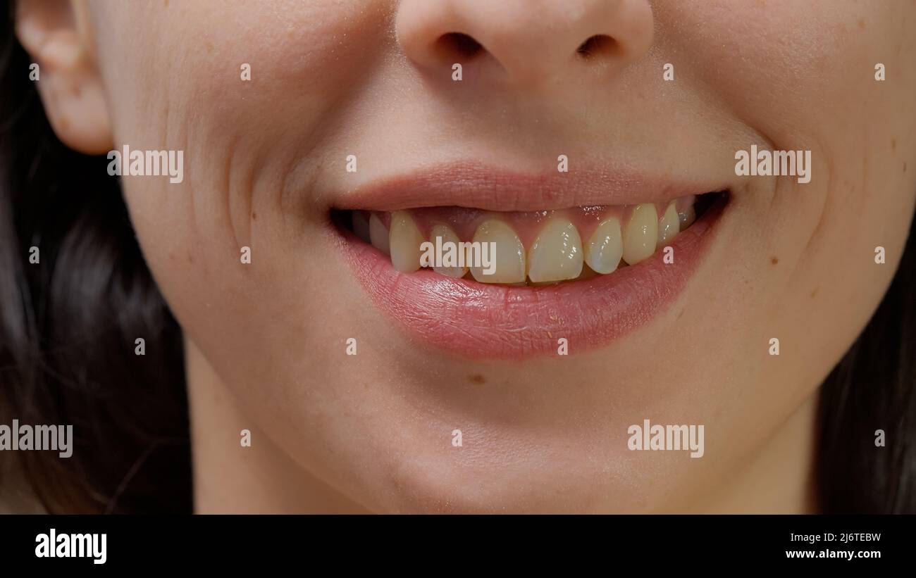 Macro shot portrait of cheerful woman smiling in front of camera ...