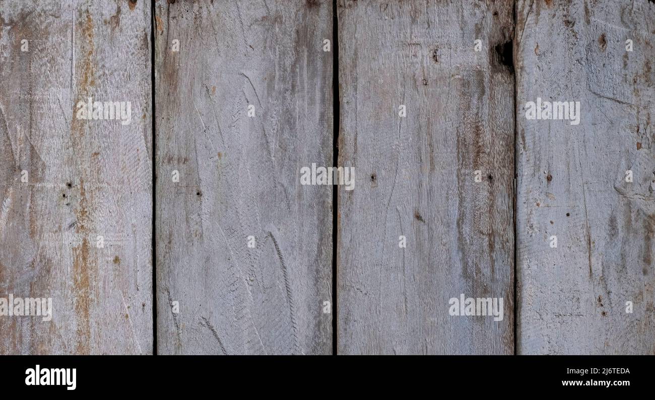 Vertical old weathered wood planks with distressed hammer markings and ...