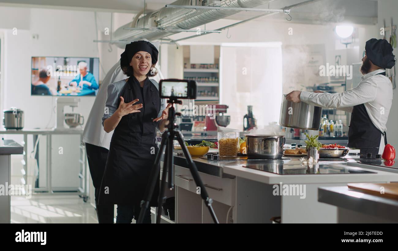 Female chef recording cooking show video on TV program, filming ...