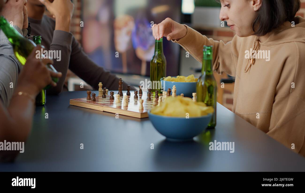 Focused woman playing strategic board games with friends, having fun ...