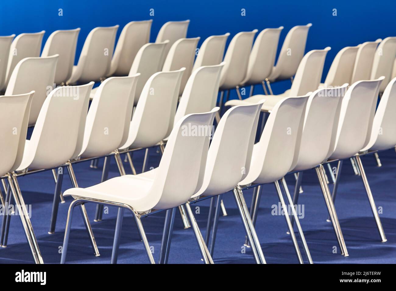 Contemporary white plastic chairs in a conference room. Workshop Stock ...