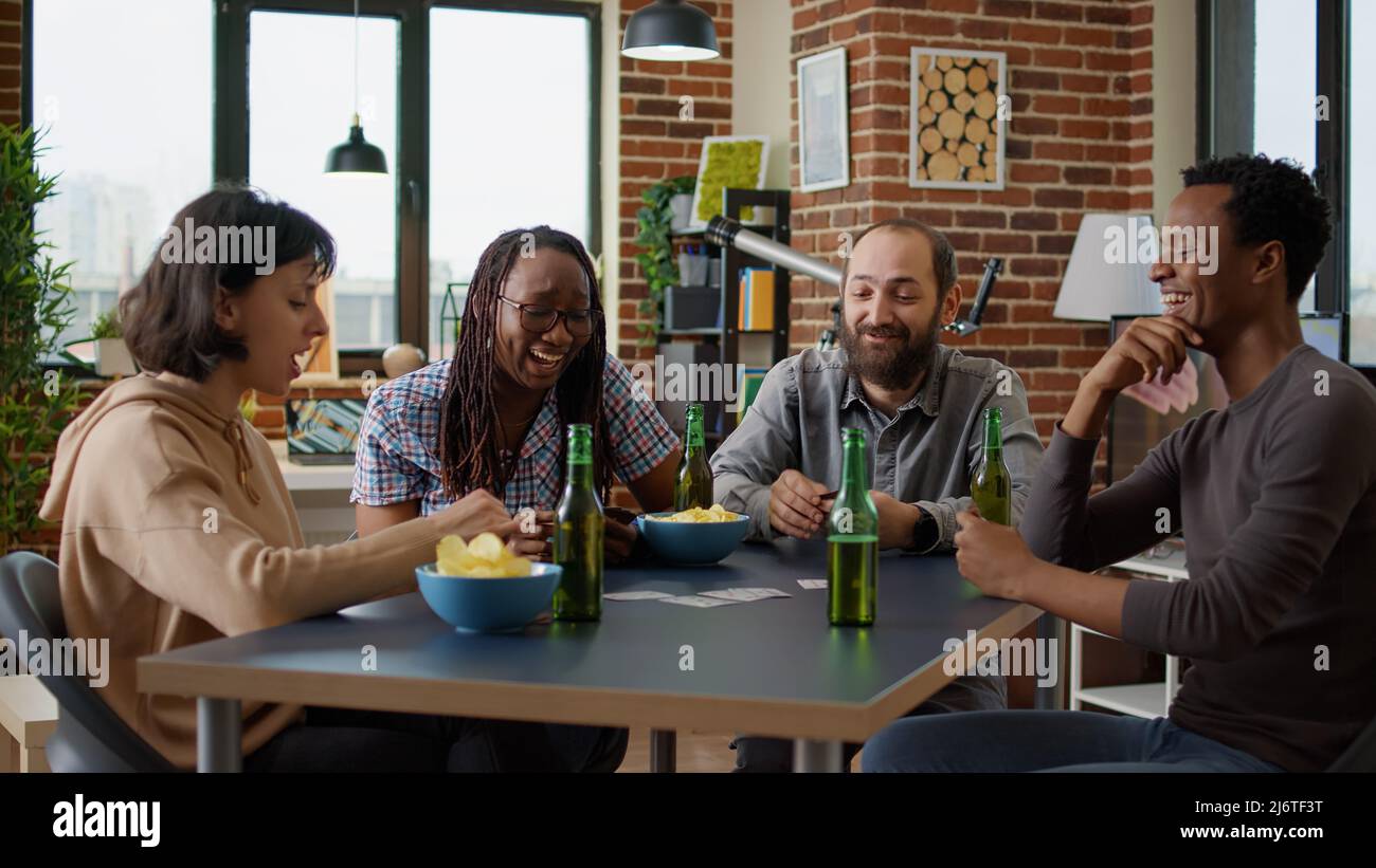 Happy group of people enjoying board strategy with cards and dice ...