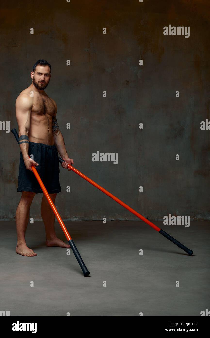 A fighter or karate man, stands in a fighting artificially pose and ...